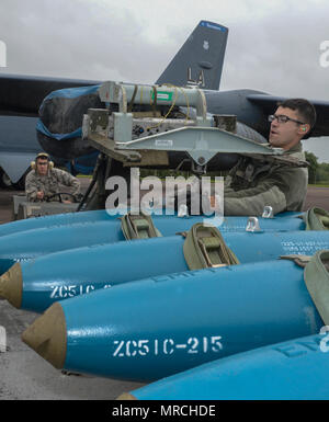 Members of the 2nd Munitions Maintenance Squadron secure a BDU-50 high ...