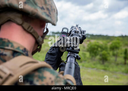 A Marine loads an M203 grenade launcher during a fire team training ...