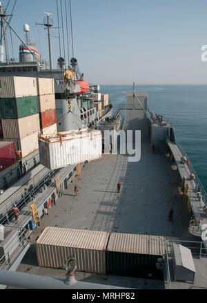 The Military Sealift Command Vessel Gem State transfers a container to ...
