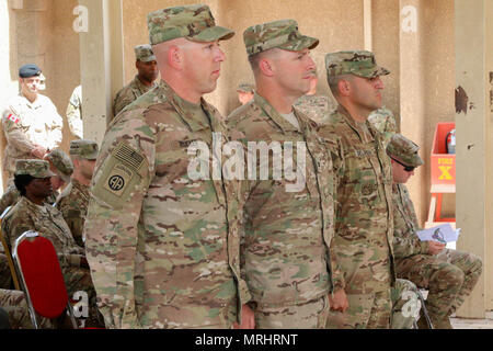 Outgoing Command Sgt. Maj. Mitchell Rucker hands the brigade colors to ...