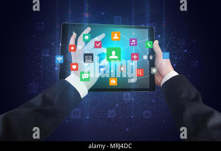 Hand using tablet with colorful bounce application symbols and icons ...