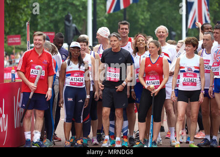 Runners race along an athletics track during a distance race at the ...