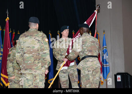 Out-going Colonel Robert Cornes hands the flag to Brigadier General R ...