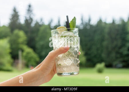 glass of mojito in female hand Stock Photo - Alamy