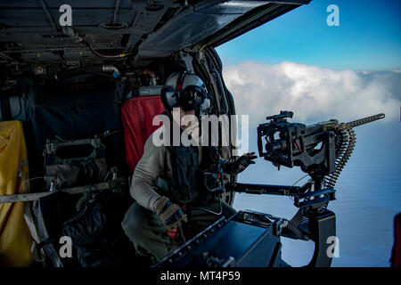 U.S. Navy Aircrewman rides in an MH-60S Seahawk helicopter Stock Photo ...
