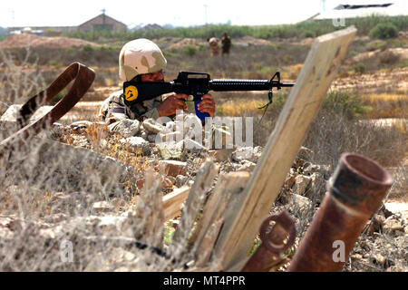 An Iraqi army soldier aims down the sight of an M16 rifle during ...