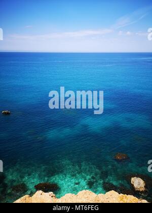 Rocky mediterranean seashore with azure and turquoise color water ...