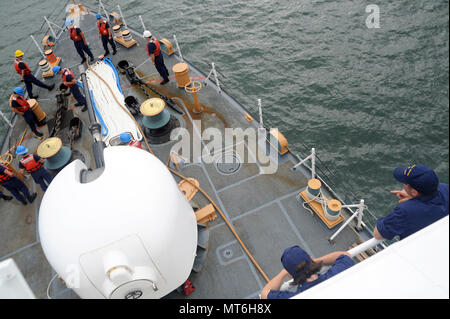 Crew members watch from the bridge of the ocean minesweeper USS INFLICT ...