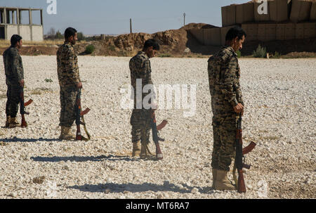Syrian Arab trainees await commands from an instructor at a Syrian ...