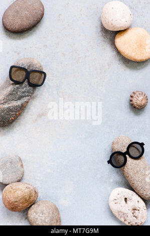 Background with various funny characters of stones on the grey textured ...