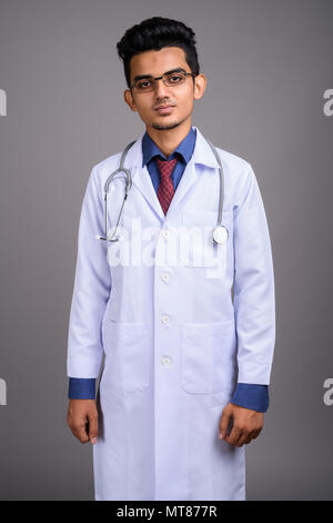 Young Indian man doctor against white background Stock Photo - Alamy