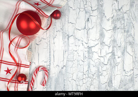 Christmas background with napkin, red baubles, ribbon and a candy cane ...