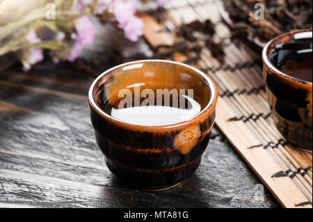 the classic brown japanese tea set on wooden table, with the word ...