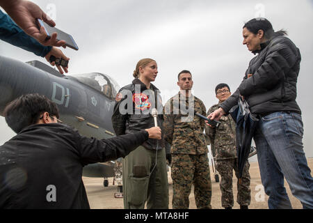 U.S. Marine Corps Capt. Kelsey Casey sits in the cockpit of an AV-8B ...