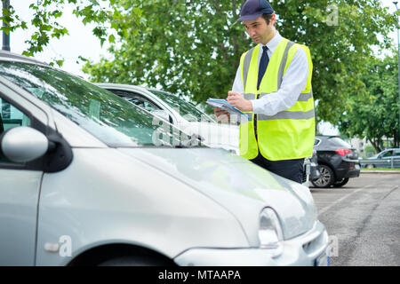 A parking enforcement officer writing a ticket - Washington, DC USA ...