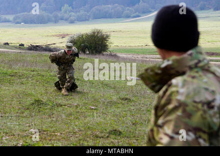 An Infantry Soldier pulls a 250 lbs. litter across a rocky terrain ...