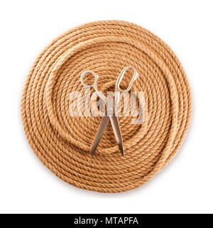 Scissors cut rope on a yellow background Stock Photo - Alamy
