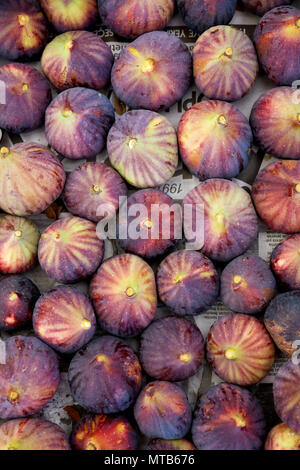 Top-down close-up of a ripe red tomato cut in half, one half showing ...