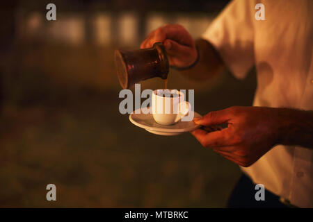 Man making traditional arabic coffee Stock Photo - Alamy