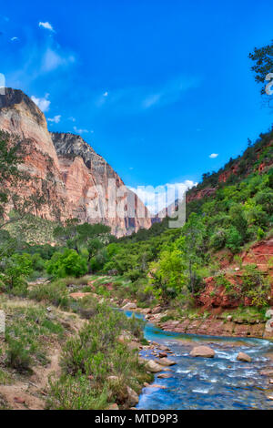 A flowing river winds its way through a picturesque mountain canyon ...