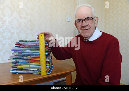 Old man with a pile of junk mail he has collected that was delivered ...