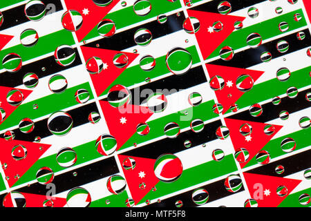 Flags of Jordan behind a glass covered with raindrops Stock Photo - Alamy