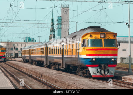 Old yellow passenger diesel train moving at the terminal Stock Photo ...