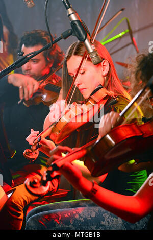 Professional symphonic string orchestra performing on stage and playing ...
