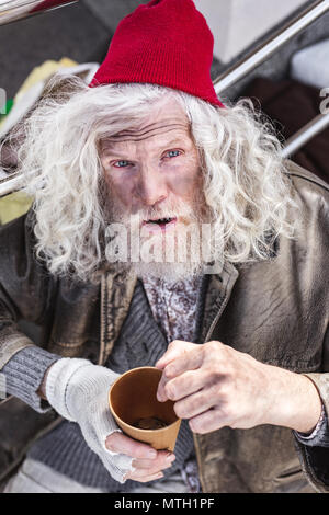 Top view of elderly homeless man sleeping on urban bench outside, using ...