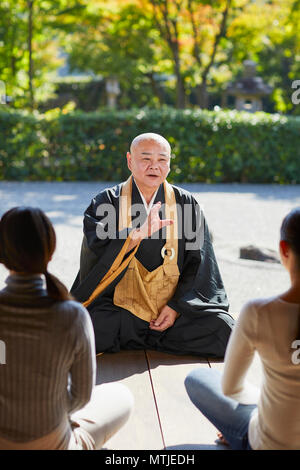 Japanese priest preaching to women at a temple Stock Photo - Alamy