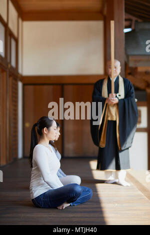 Japanese priest preaching to women at a temple Stock Photo - Alamy