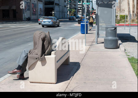 Vegas - tramp on bench with coat on head Stock Photo - Alamy