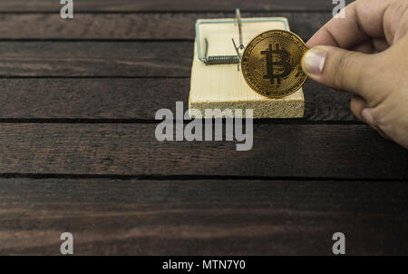 wooden mouse trap and man holds backside of bitcoin Stock Photo - Alamy