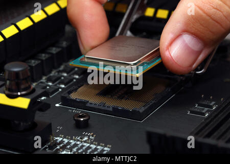 Installing modern central processor unit into motherboard Stock Photo ...