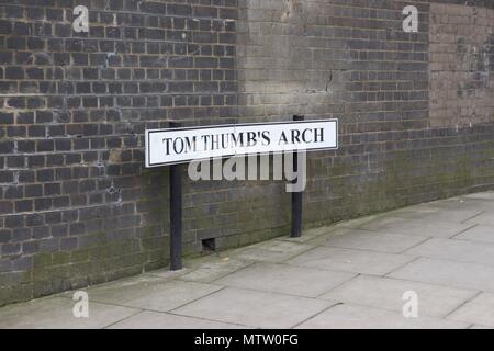The road sign for Tom Thumb's Arch, a pedestrian walkway under a bridge ...