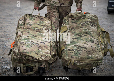A combat camera Airman takes their gear to the barracks upon arrival at ...