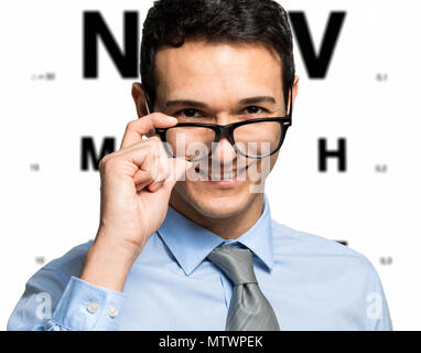 Man taking an eye exam and wearing glasses Stock Photo - Alamy