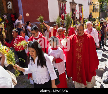 A Roman Catholic priest sprinkles holy water to devotees and to ...