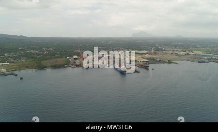 Aerial view of shipyard with ships in docks, cranes and warehouses ...