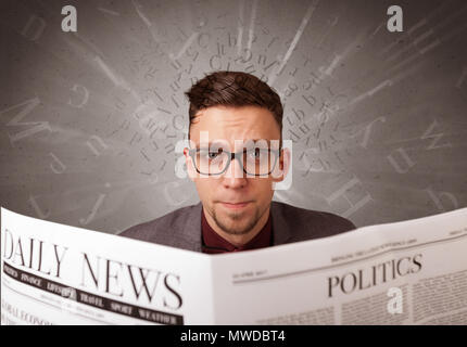 Young smart businessman reading daily newspaper with business plan ...