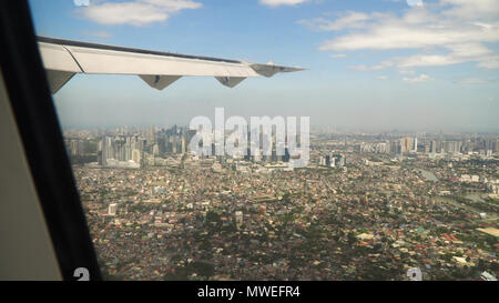 Aerial view of Manila city. Fly over city with skyscrapers and ...