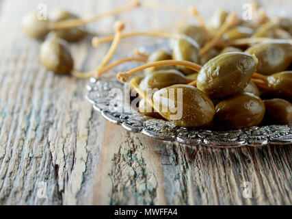 Pickled caper berries in metal dish . Edible fruits of Capparis ...