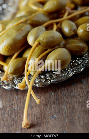 Pickled caper berries in metal dish . Edible fruits of Capparis ...
