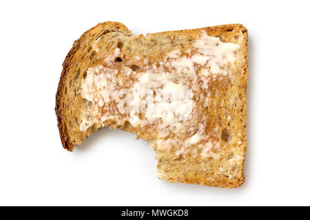 Half eaten buttered slice of whole wheat toast and whole dry slice of ...