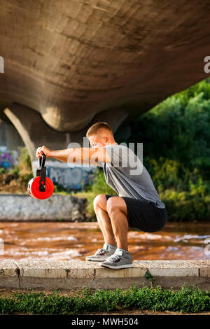 Man Working Out With Kettle Bell Outdoors - Bodybuilder Doing Heavy ...