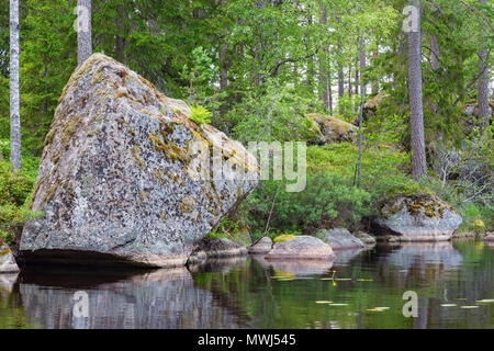 Glacial erratic rock located on a beach Stock Photo - Alamy
