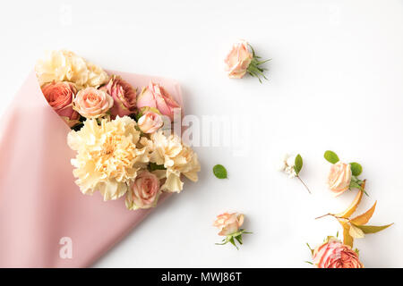 pink roses in paper wrap isolated on white Stock Photo - Alamy