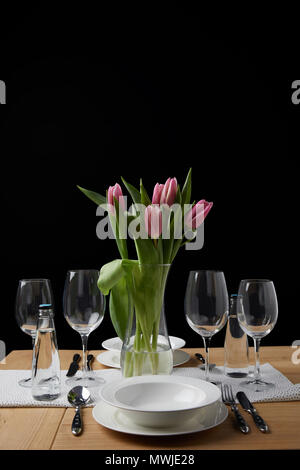 Table setting with white plates on grunge background Stock Photo - Alamy