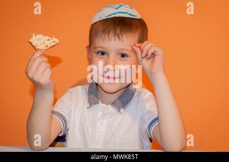 Happy little Jewish child with a kippah on his head looking forward for ...
