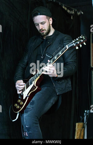 The guitarist plays on guitar in a dark room. Hands of a Guitar player ...